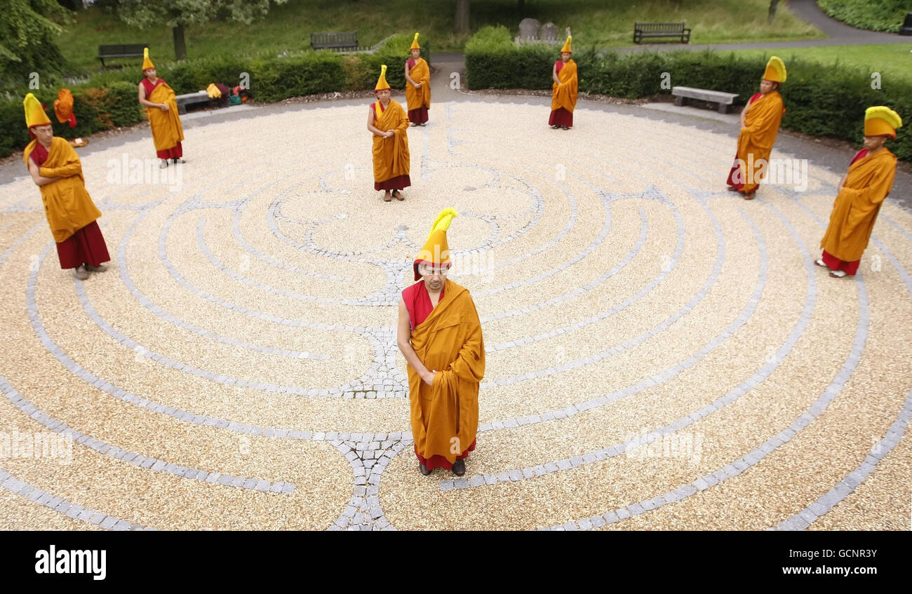 Buddhist monks wearing ceremonial clothes walk a Labyrinth in George ...