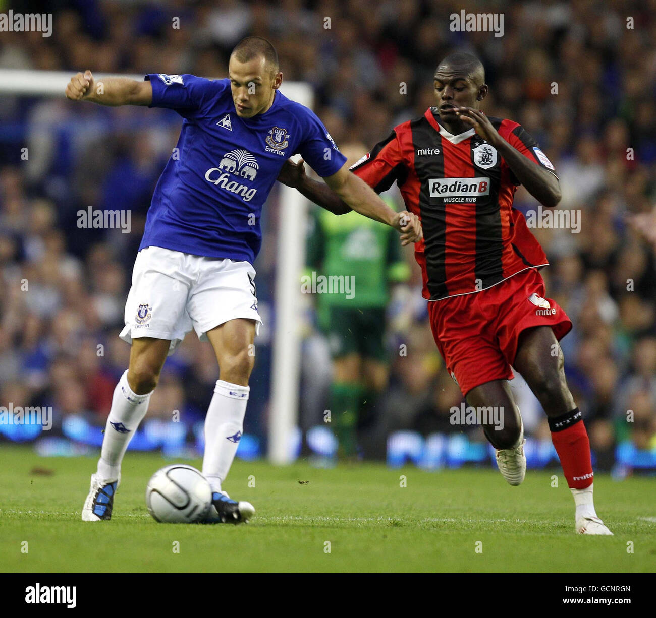 Everton's Johnny Heitinga (left) and Huddersfield Town's Theo Robinson ...