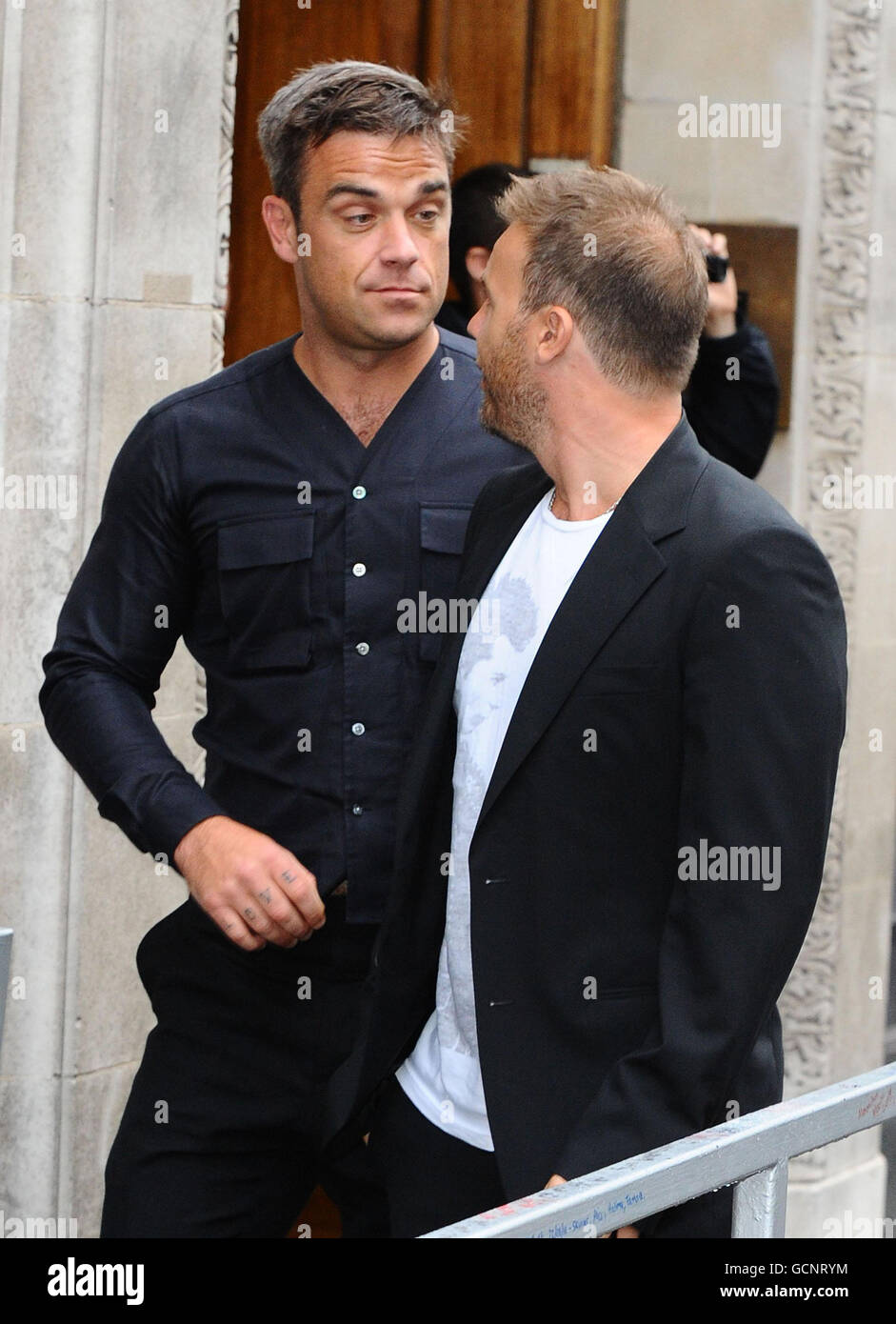 Robbie Williams (left) and Gary Barlow leave Radio 1 in London after ...