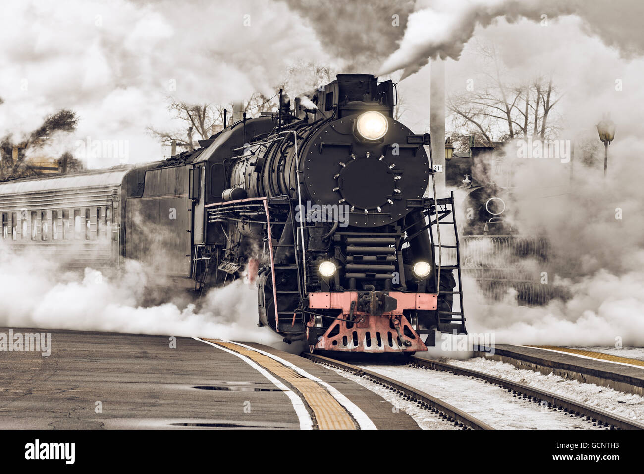 Retro steam train departs from the station Stock Photo - Alamy