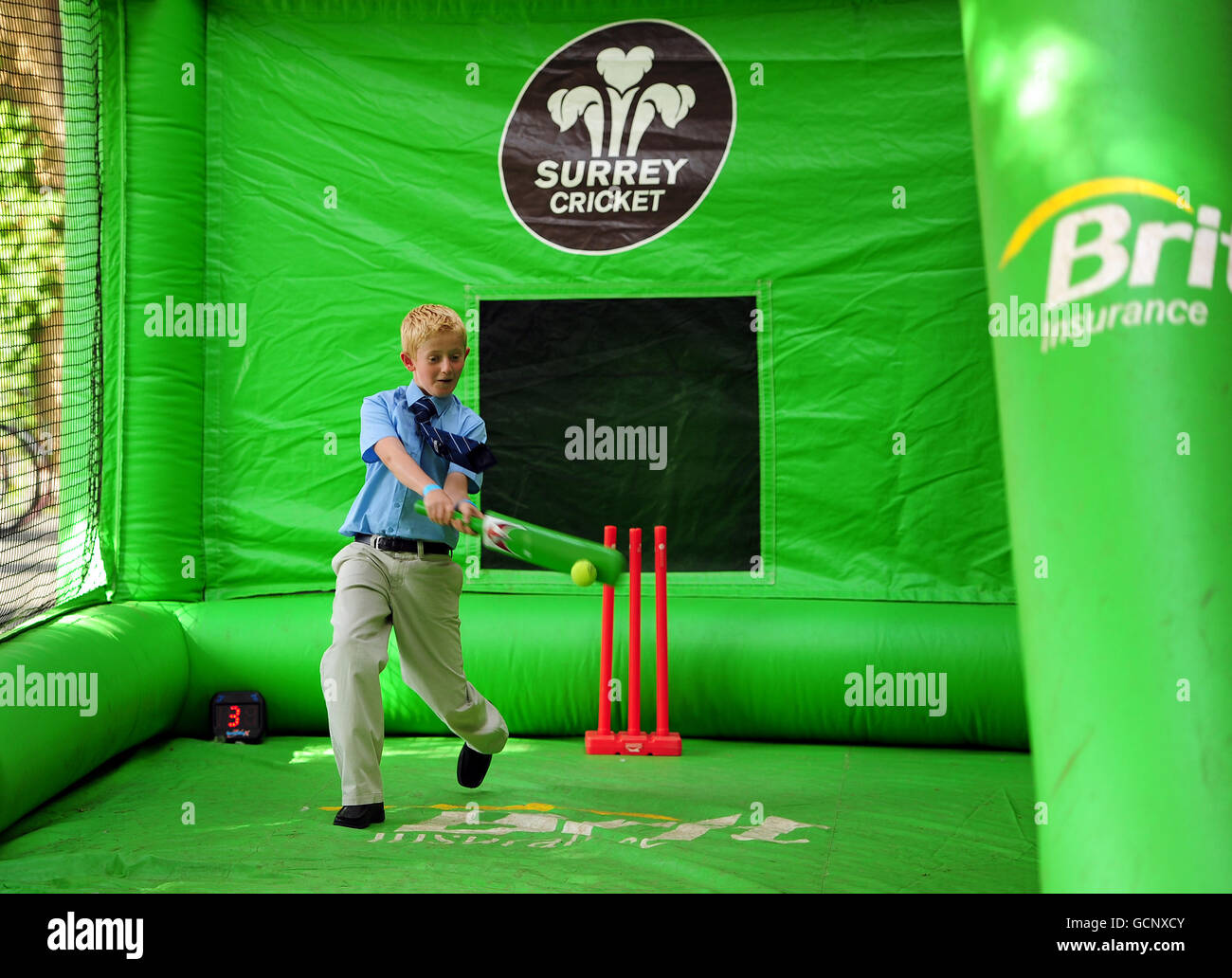 Kids play in inflatable set of nets around the ground hi-res stock ...