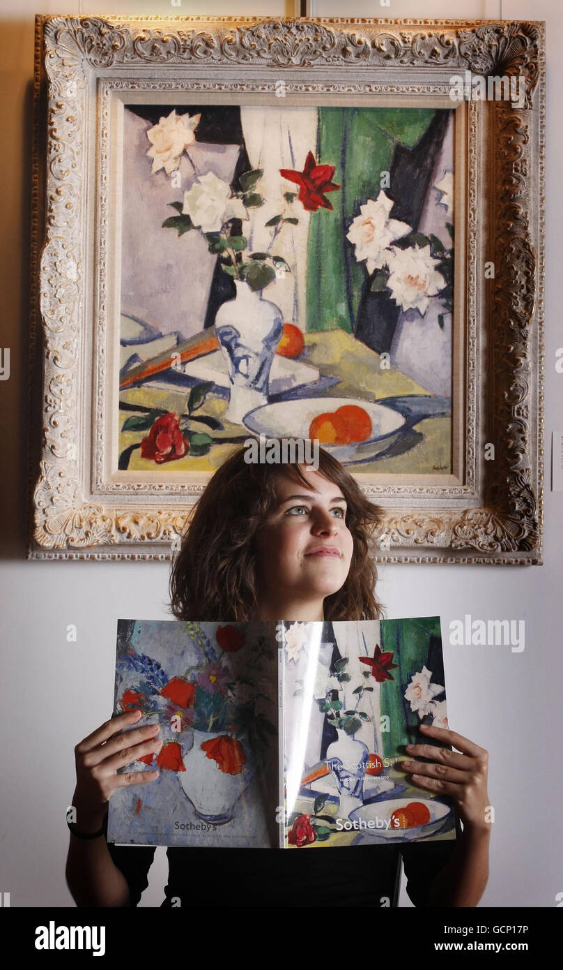 Sotheby's employee Bryn Sayles is pictured with a work by artists ...