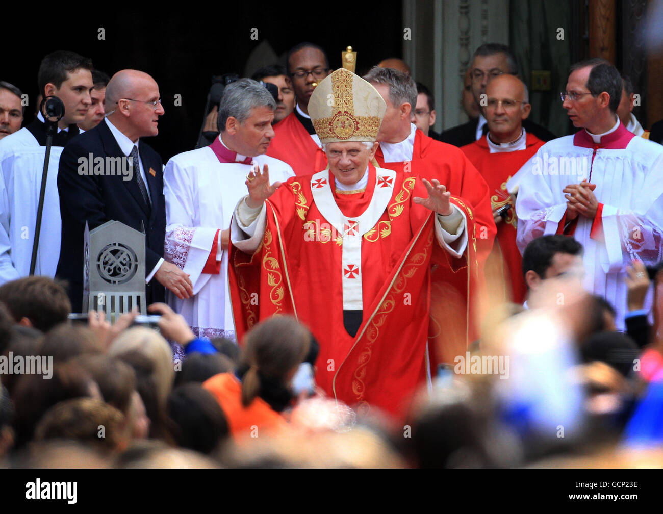 Pope Benedict XVI greets the crowd gathered to greet him, as he stands ...