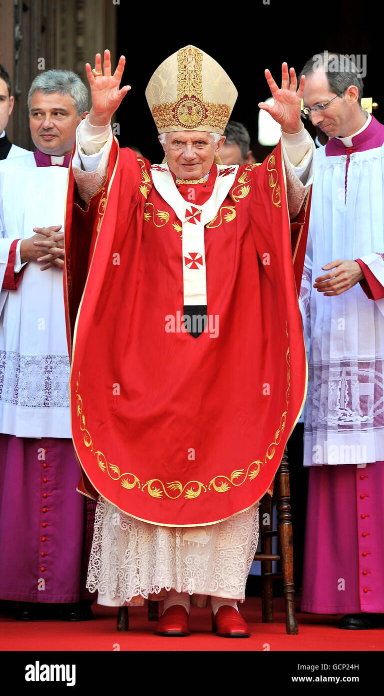 Pope Benedict XVI waves to the crowd gathered to greet him, as he ...