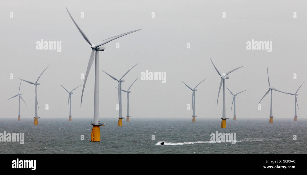A small boat passes through the windmills of the Thanet Offshore Wind ...