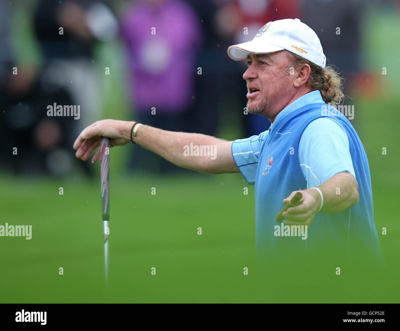 Europe's Miguel Angel Jimenez smokes a cigar as he lines up a putt at ...