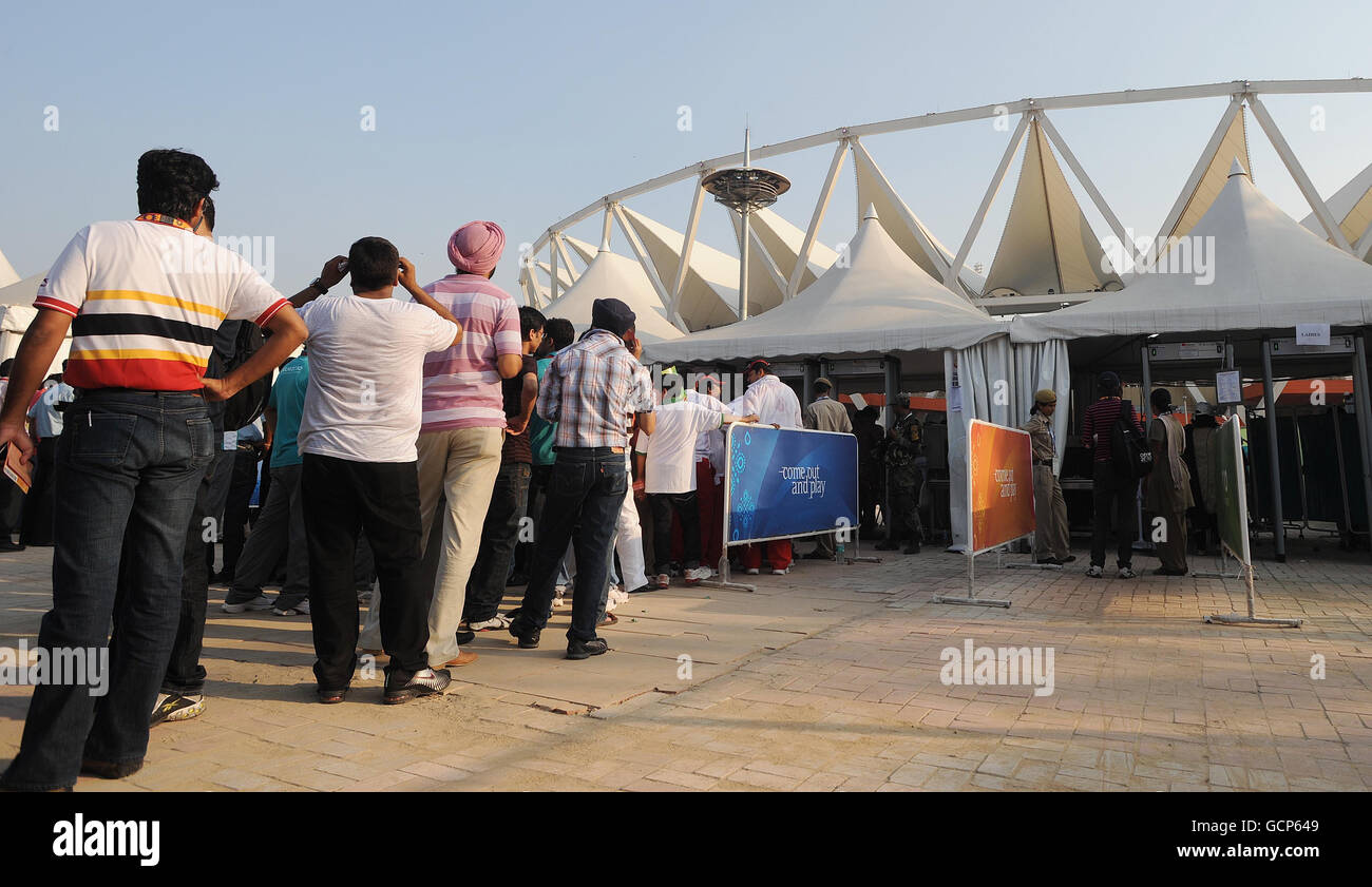 People go through security checks outside the Jawaharlal Nehru Stadium ...
