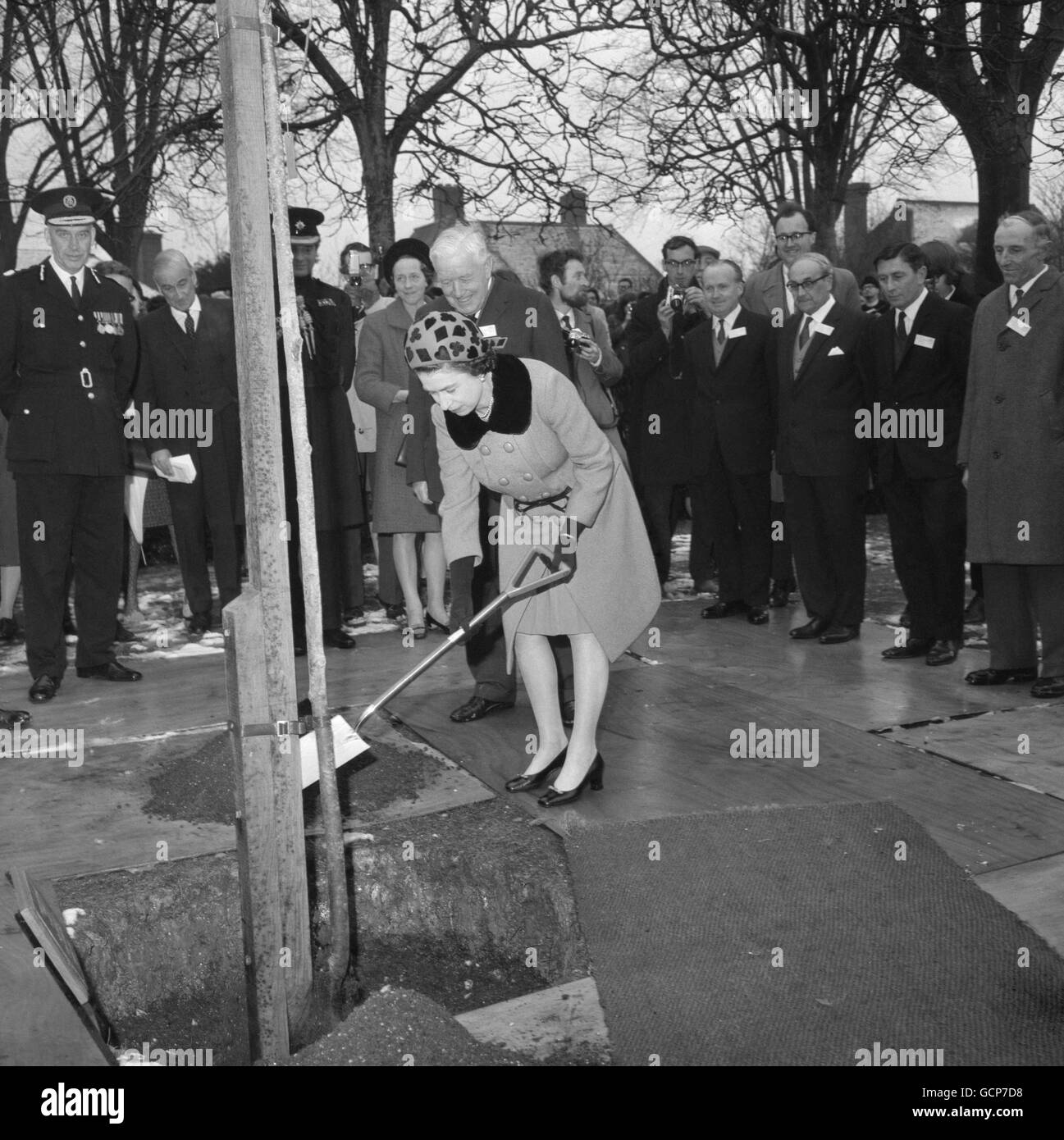Queen Elizabeth II planting a mountain ash tree during a ceremony at ...