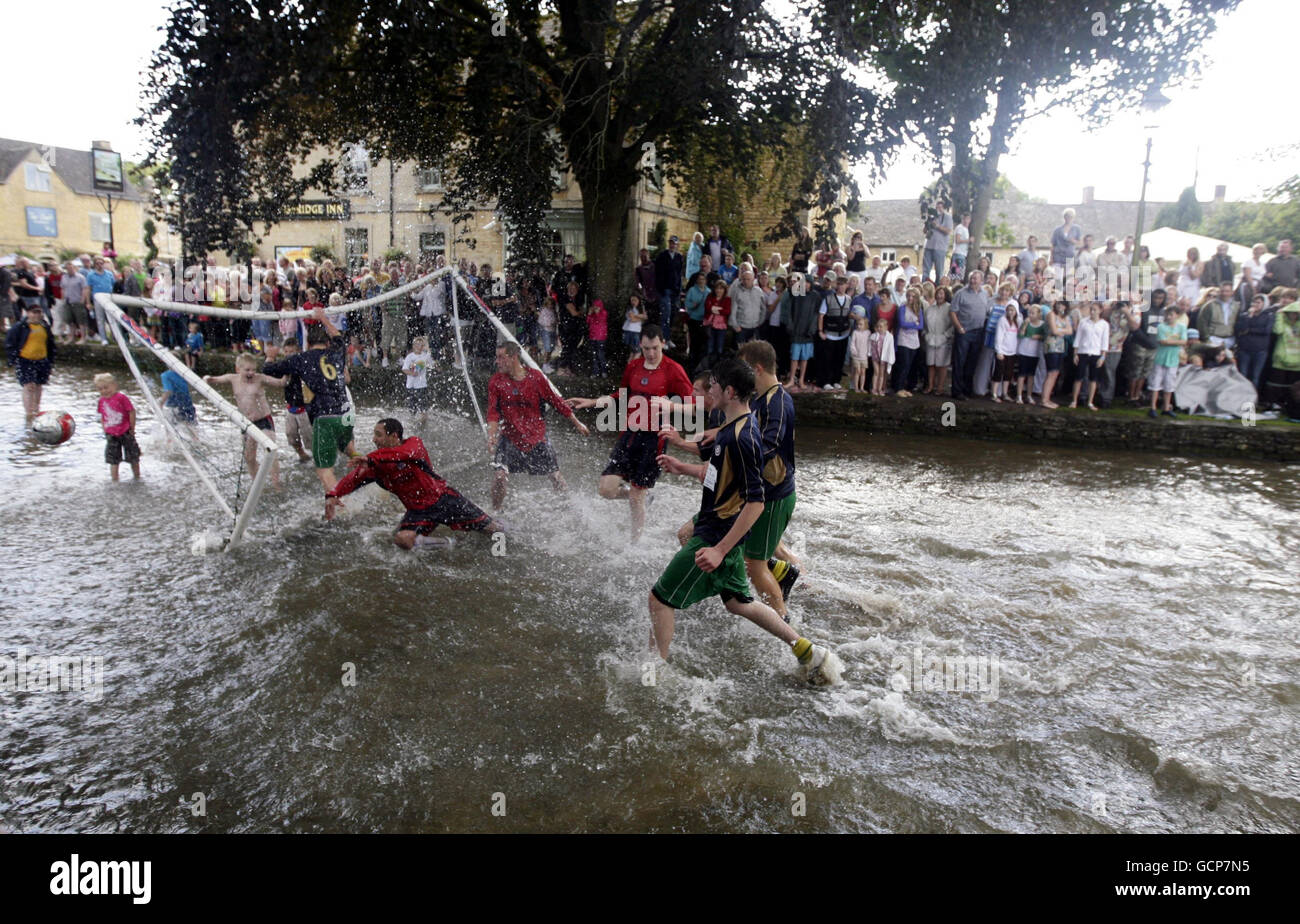 Players during the annual river football match in the River Windrush ...