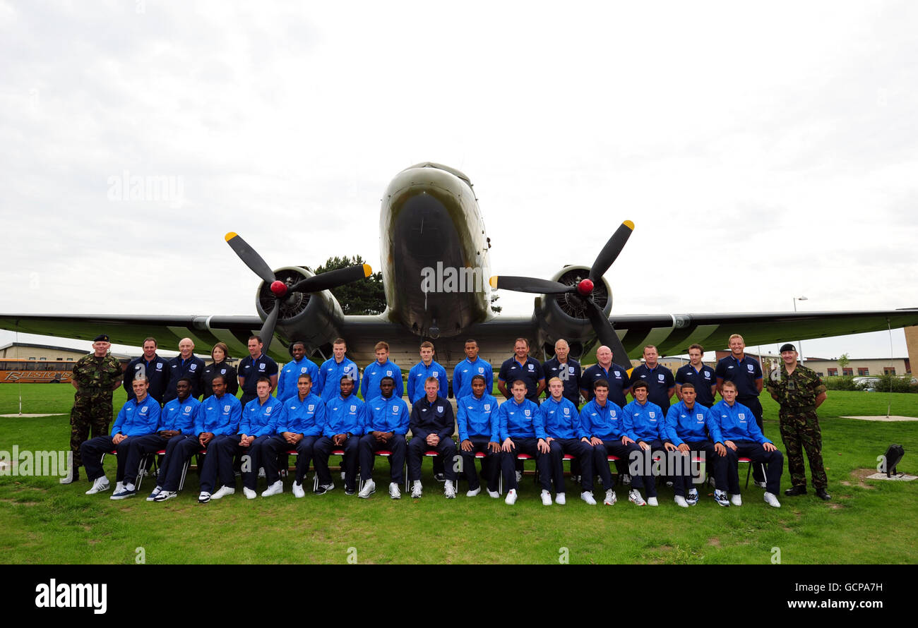 A team photograph of the U21 squad in front of a Douglas Dakota C-47B ...
