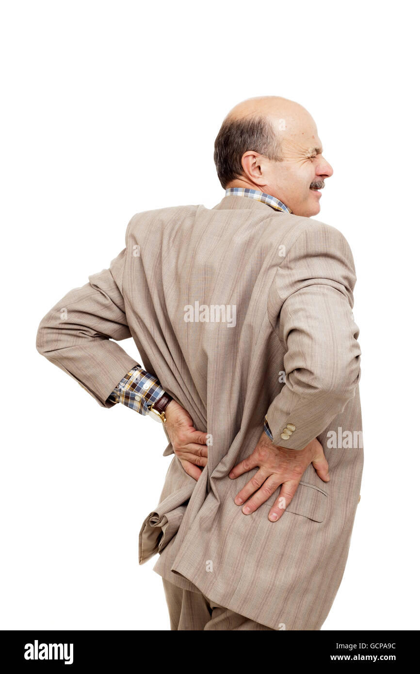 Elderly man holds on lower back and wincing Stock Photo - Alamy