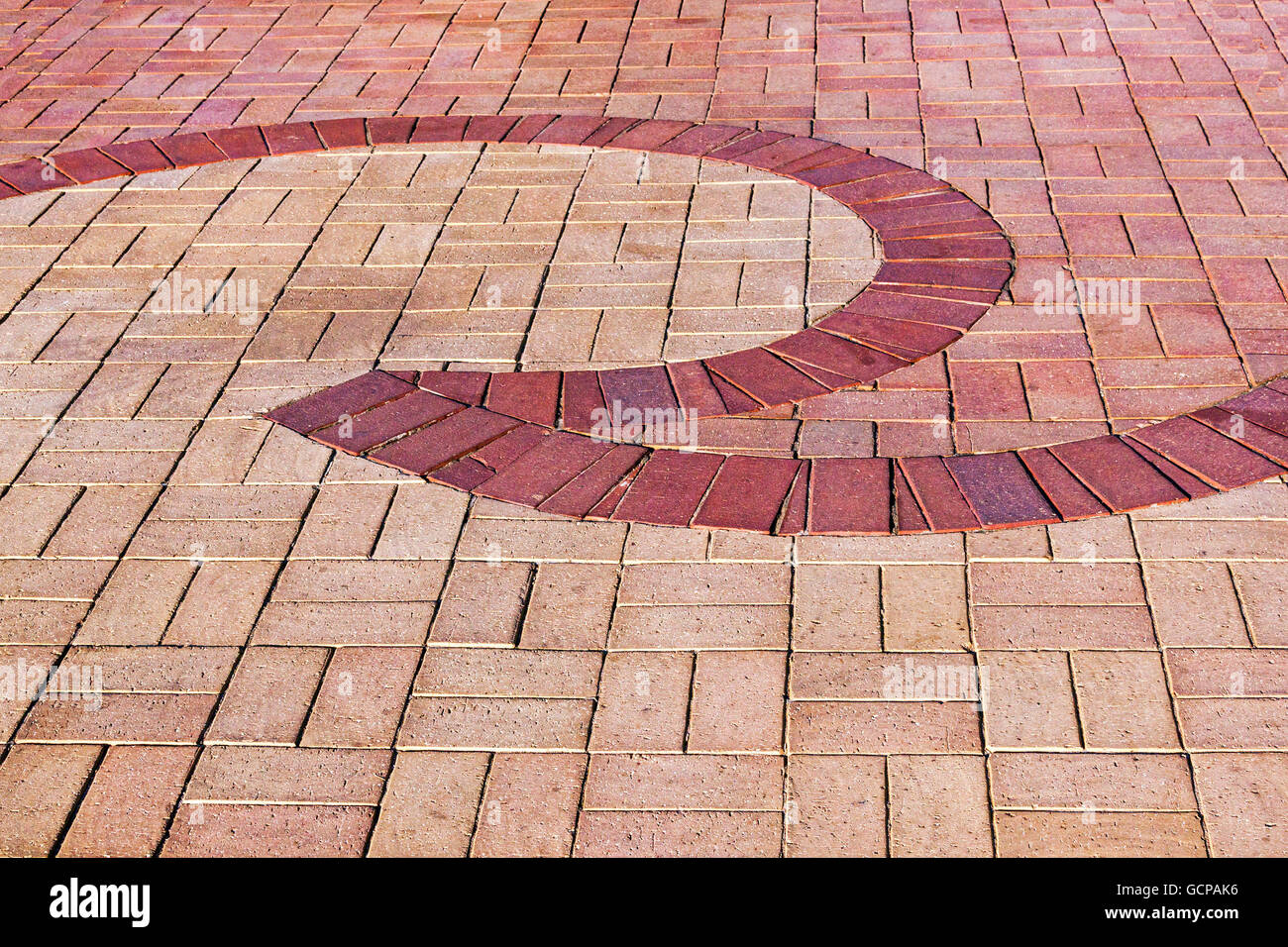 close up brick paved promenade background with red curved patterns and ...