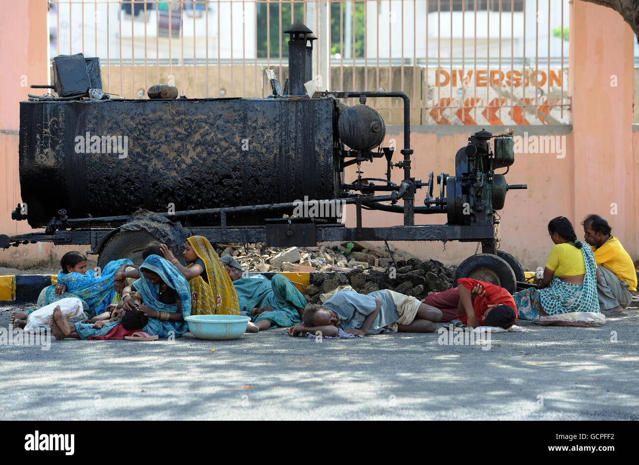 Workers rest as construction work continues on a new bridge following ...