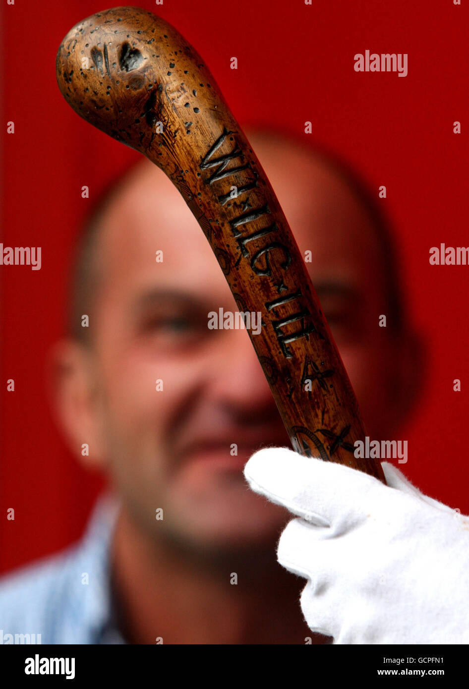 Lyon and Turnbull auctioneer Philip Gregory views a walking stick ...