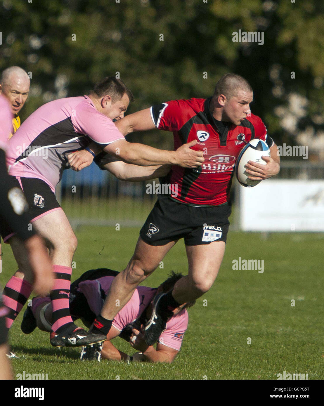 Glasgow Hawks' Adrian Smith (left) attacks the Ayr defence during the ...