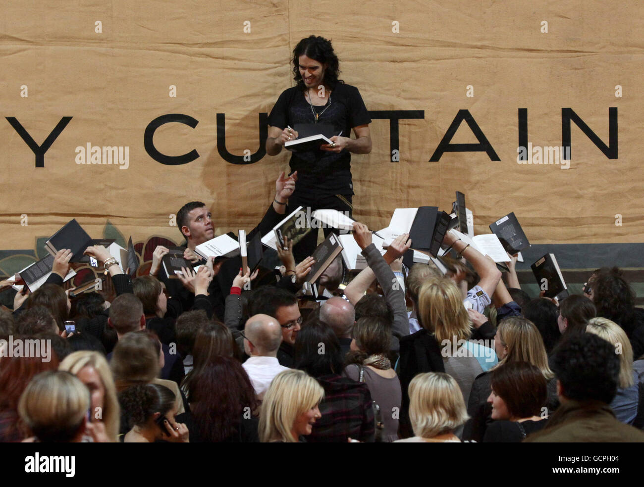 Russell Brand signing autographs for fans after performing on stage ...