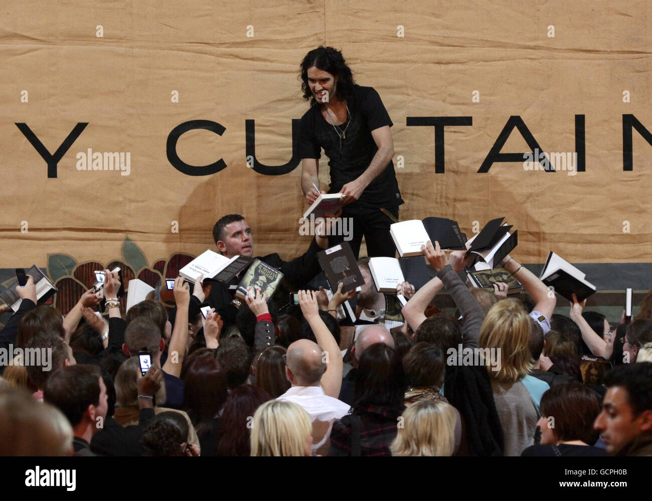 Russell Brand signing autographs for fans after performing on stage ...
