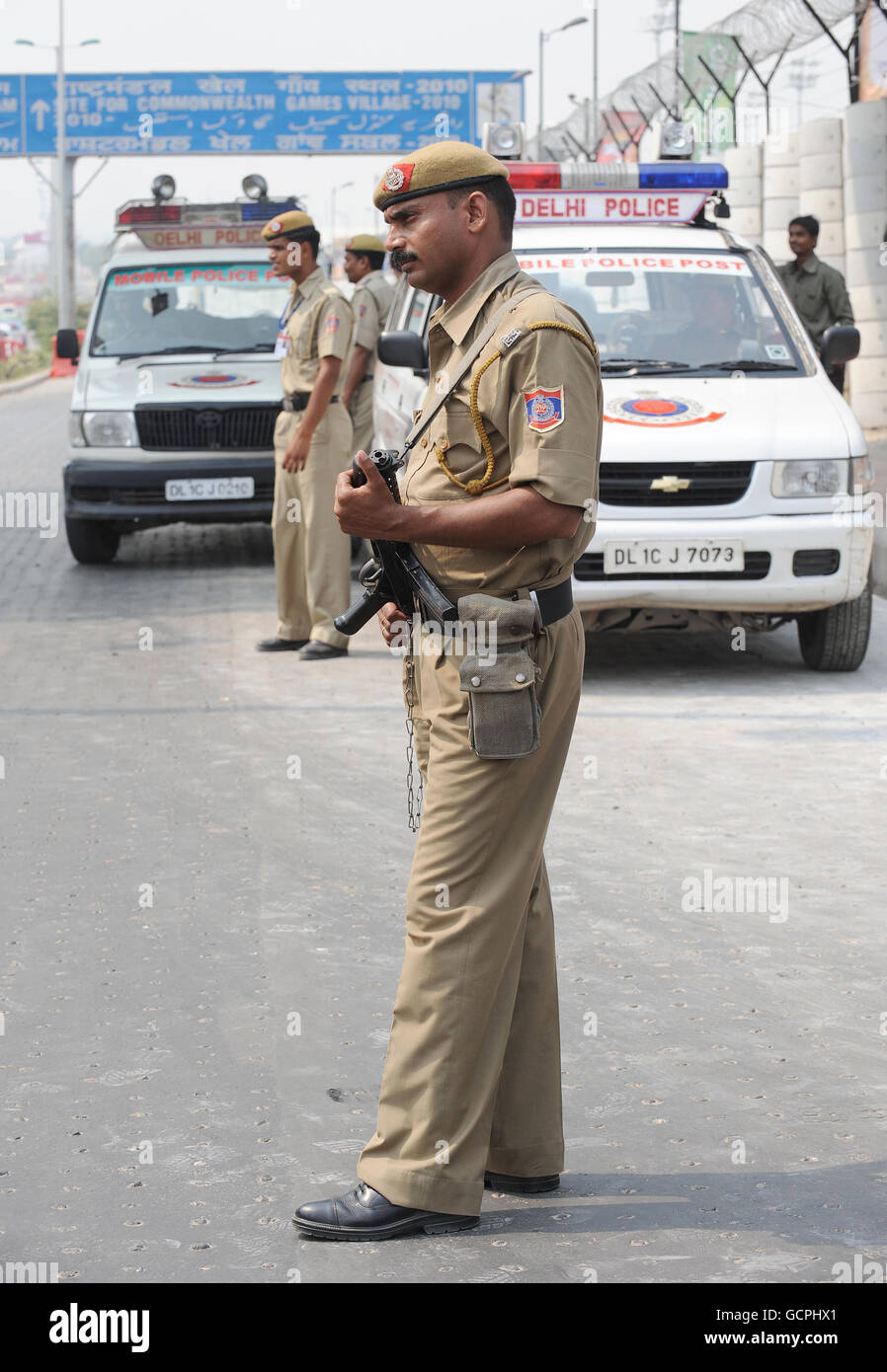 Armed police guard entrance to athletes village in new delhi hi-res ...