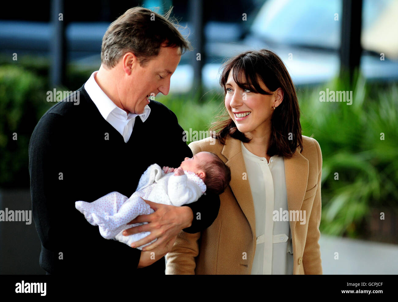 Prime Minister David Cameron, holds his child Florence, as he poses ...