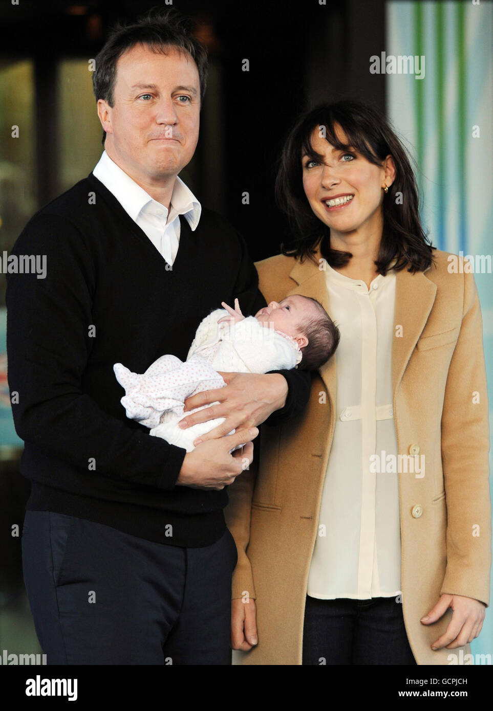 Prime Minister David Cameron, holds his child Florence, as he poses ...