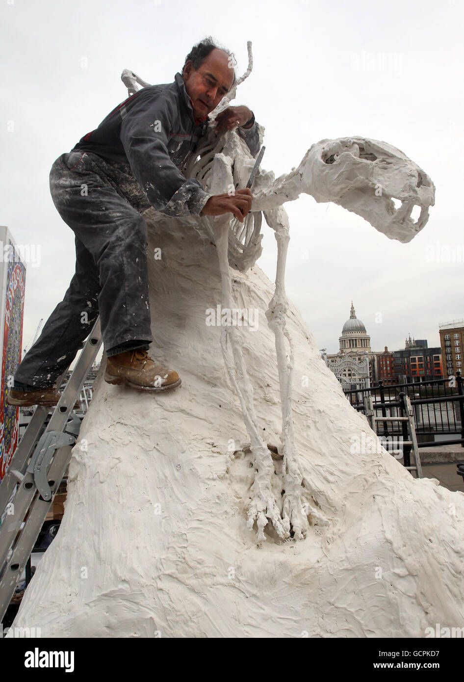 Artist Mark Coreth with his artwork of a life-size tigress on the banks ...