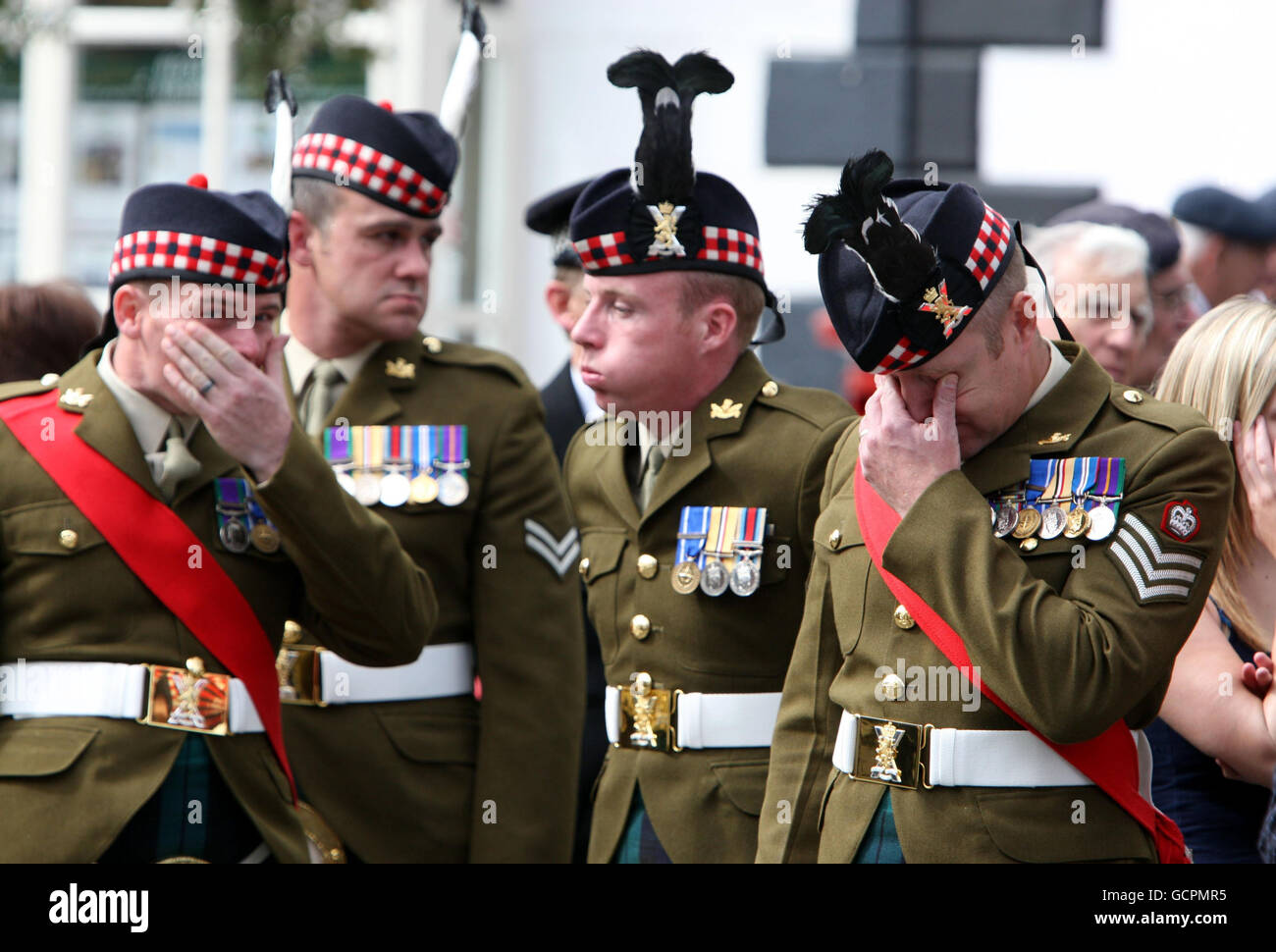 Mourners watch the coffin of Lance Corporal Joseph Pool passing through ...