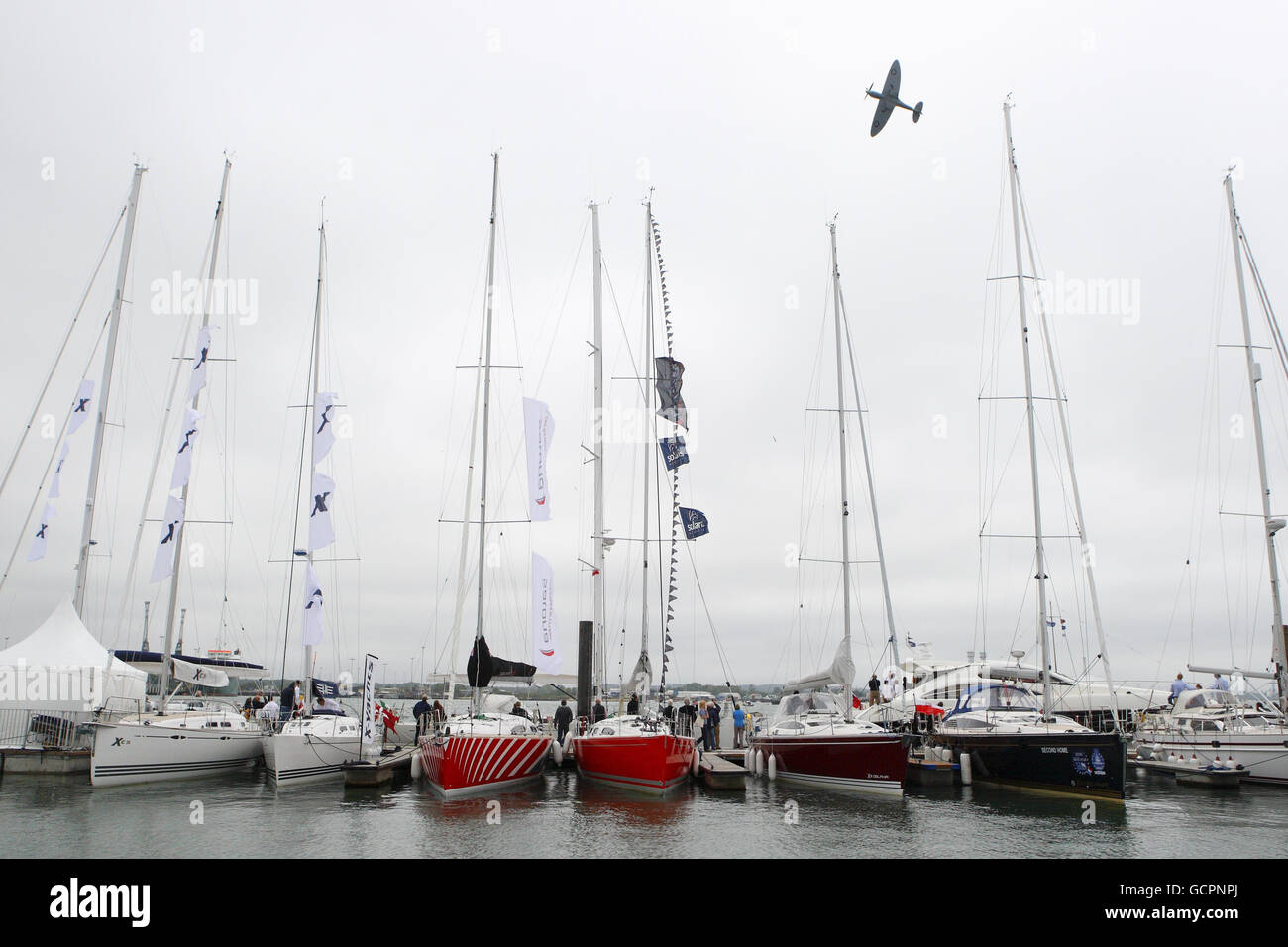A Spitfire flies overhead during the opening ceremony of the ...
