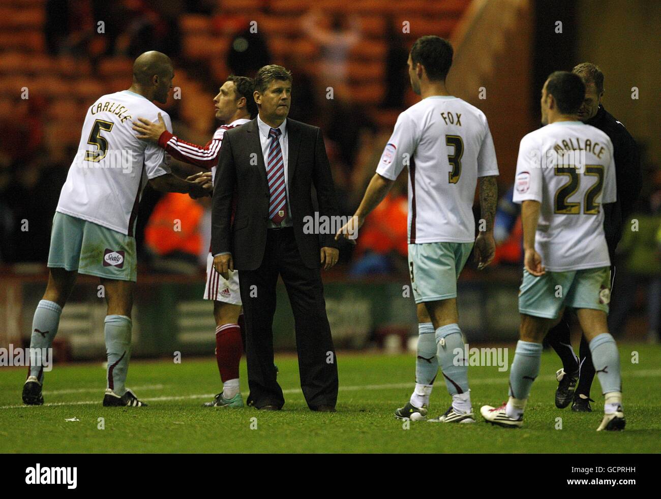 Burnley manager Brian Laws (left centre) commiserates with his dejected ...