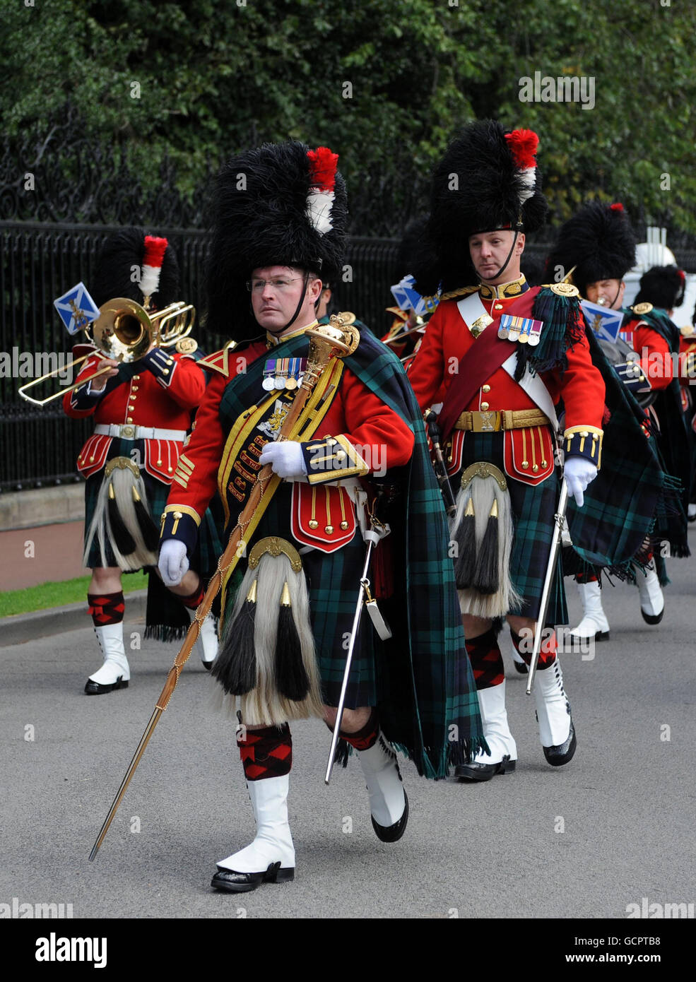 Members of the Royal Regiment of Scotland Band march into the grounds ...