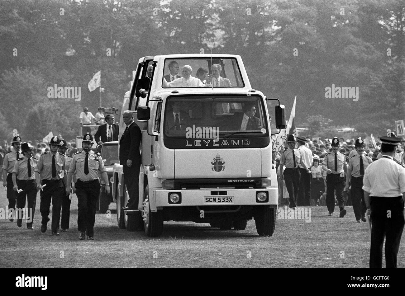 Pope John Paul II waves from his "Popemobile" as he arrives to conduct ...