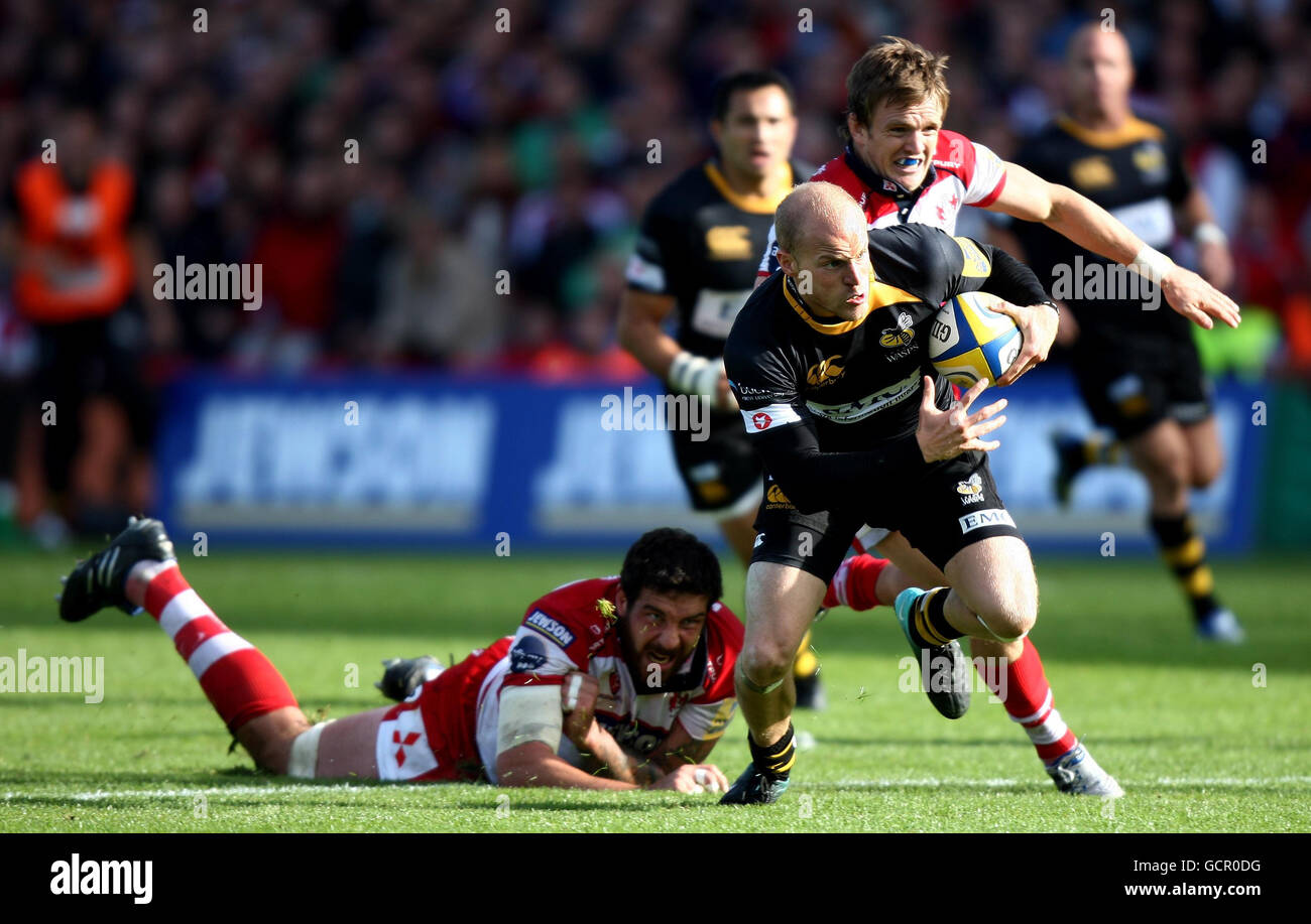 Wasps' Joe Simpson eludes the tackle of Gloucester's Jim Hamilton to ...