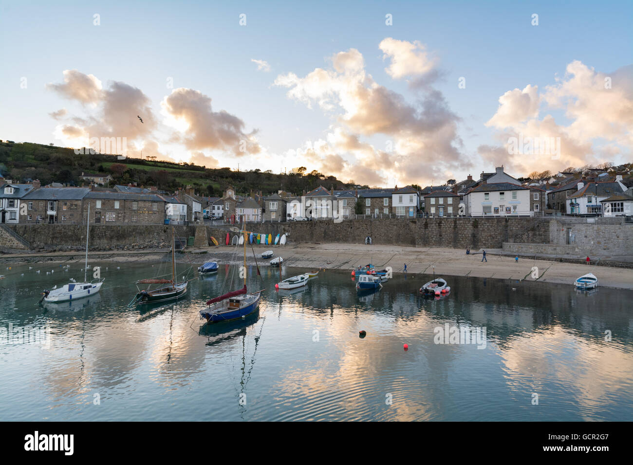 Mousehole harbour with clouds reflecting in the water Stock Photo - Alamy
