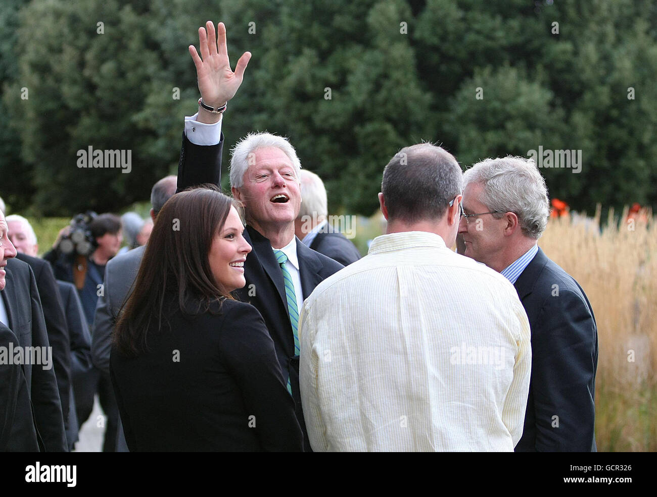 Former US President Bill Clinton waves to students at University ...