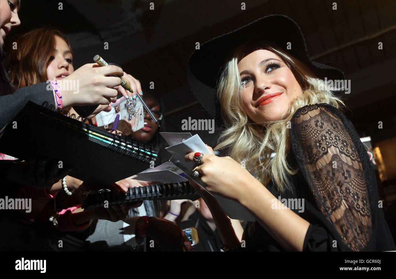Singer Pixie Lott signs autographs after launching her autumn/winter ...