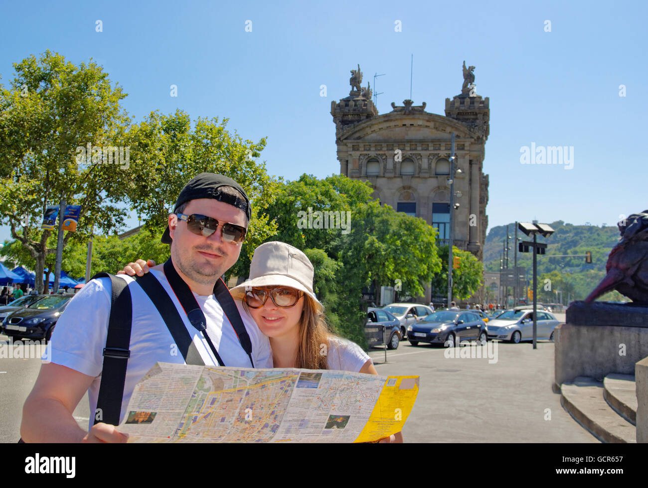 Tourists with a city map in La Rambla Street in the center of Barcelona ...