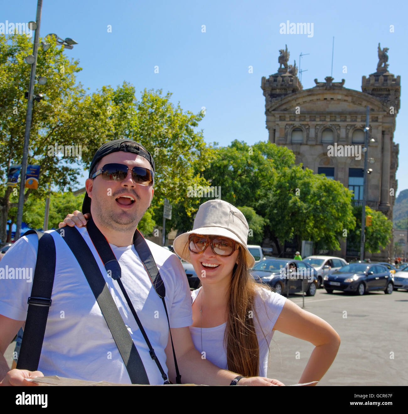 Tourists and a city map in La Rambla Street in the center of Barcelona ...