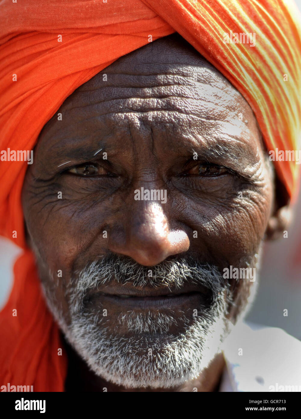 A local man in costume poses outside the Nehru Stadium, the main ...