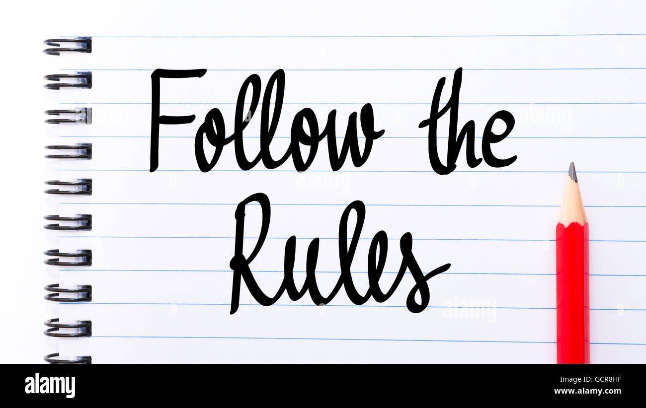 Follow The Rules written on notebook page with red pencil on the right ...