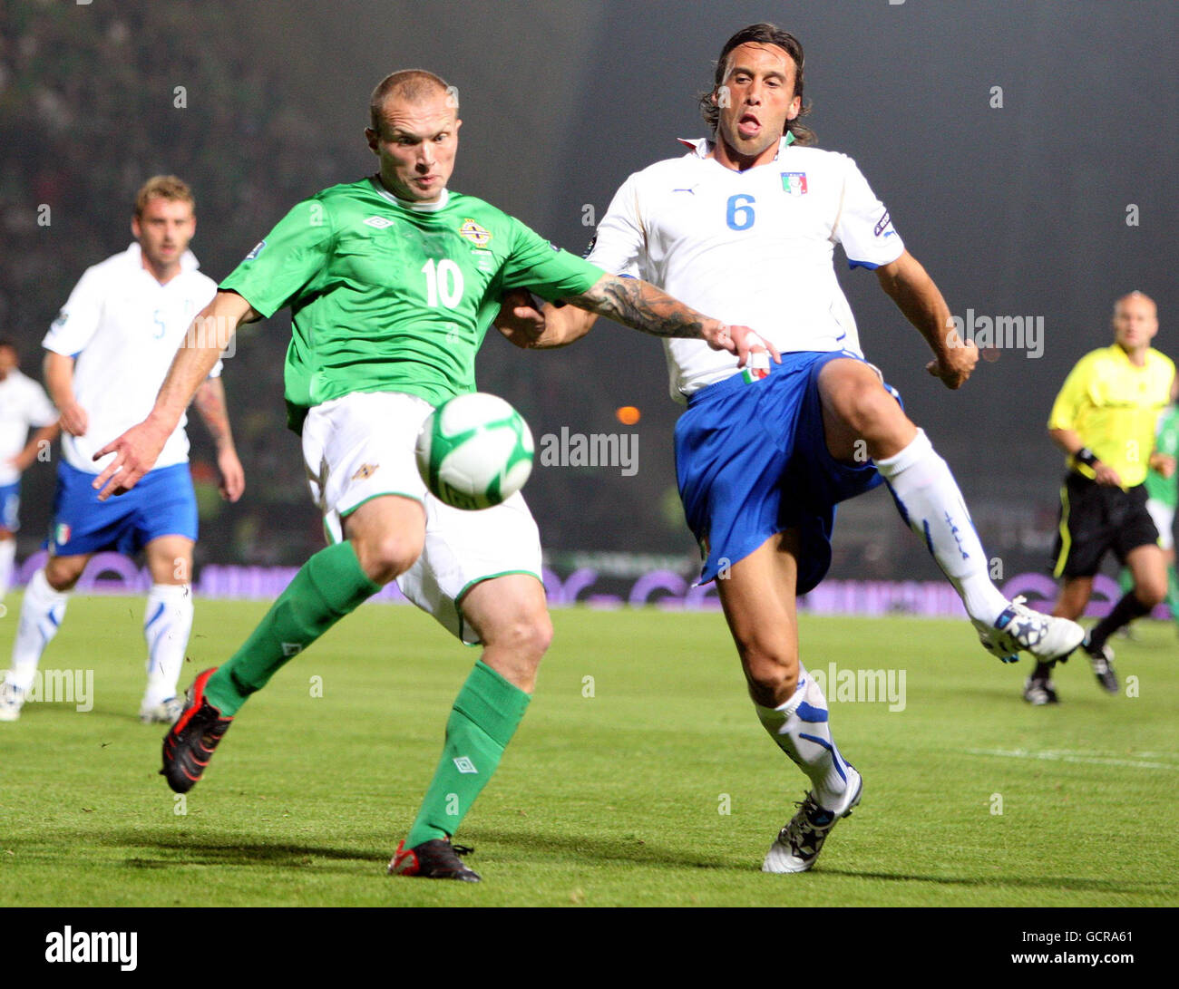 Northern Ireland's Warren Feeney battles with Italy's Stefano Mauri ...
