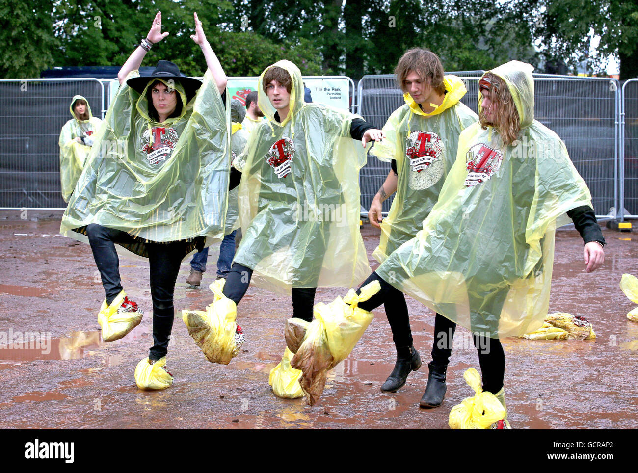 Members of the band The Struts wearing their emergency ponchos (left ...