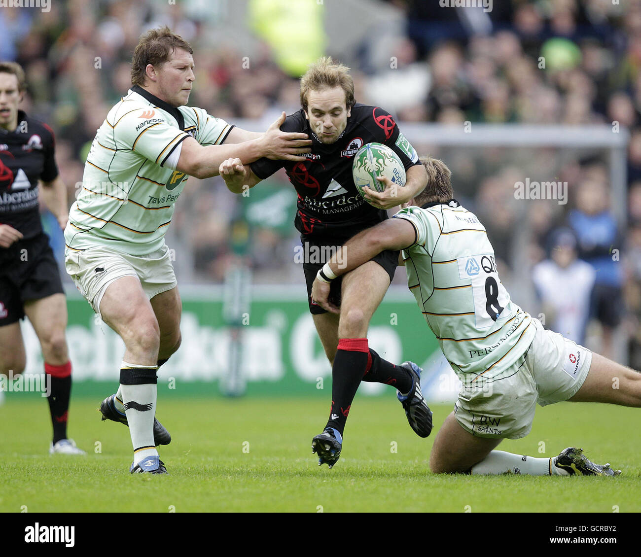 Edinburgh's David Blair (centre) is tackled by Northampton Saints ...