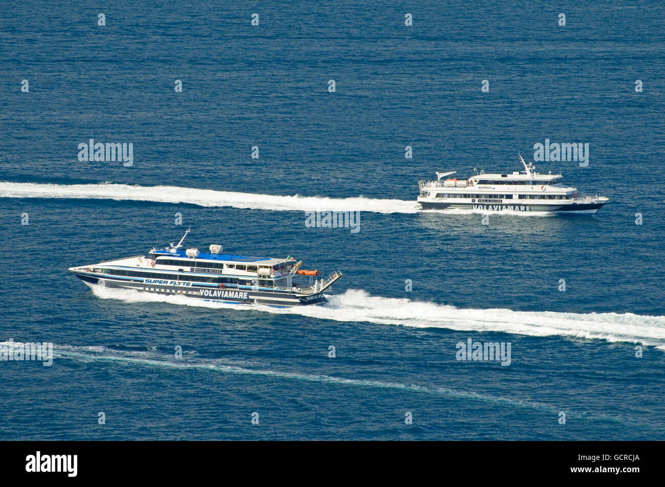 Ferries to Ischia and Capri pass each other in the Bay of Naples near ...