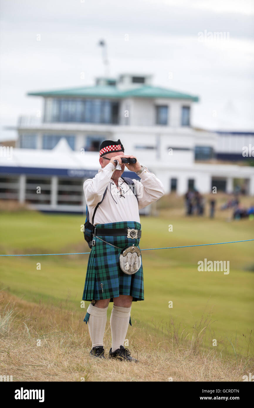 A fan watches the action in front of the Castle Stuart Clubhouse and ...