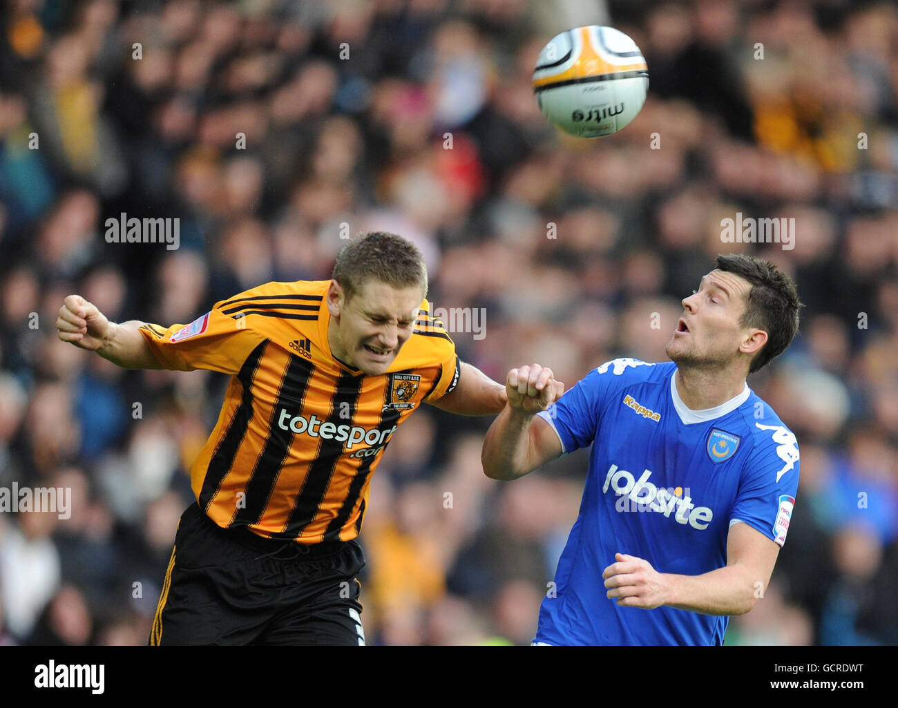 Hull City's Andy Dawson and Portsmouth's David Nugent battle for the ...