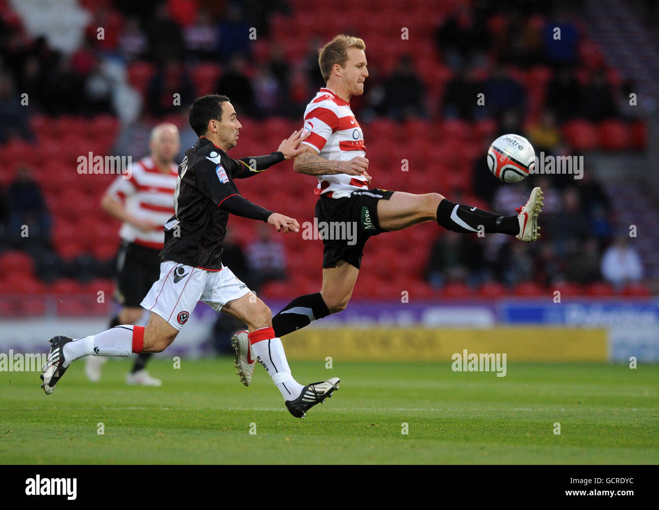Doncaster Rovers' James Coppinger (right) controls the ball under ...