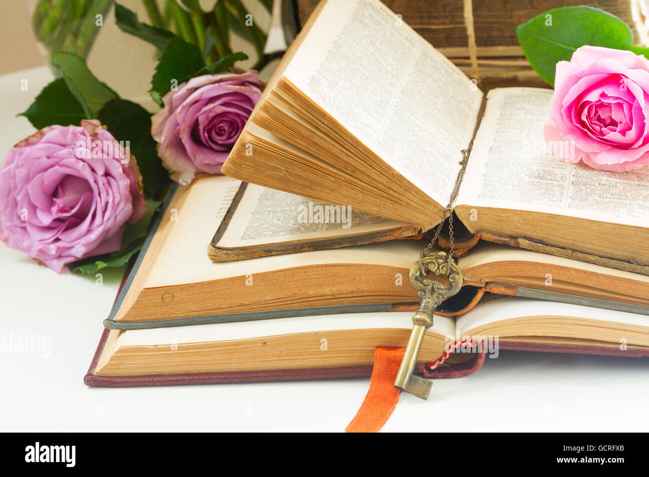 Old books with rose flower Stock Photo - Alamy