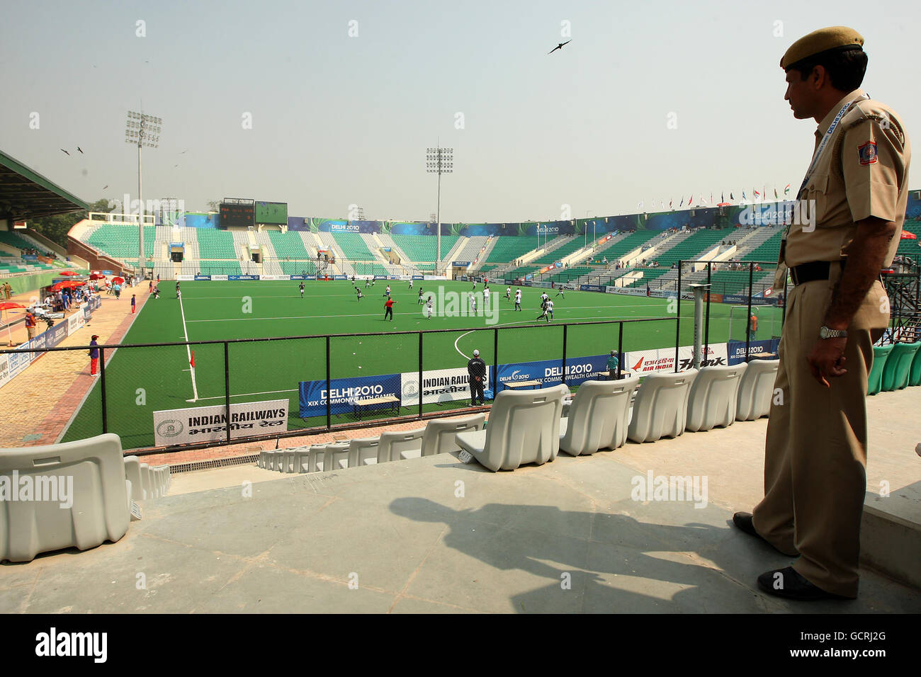 A security guard looks over the view of the virtually empty stadium at ...