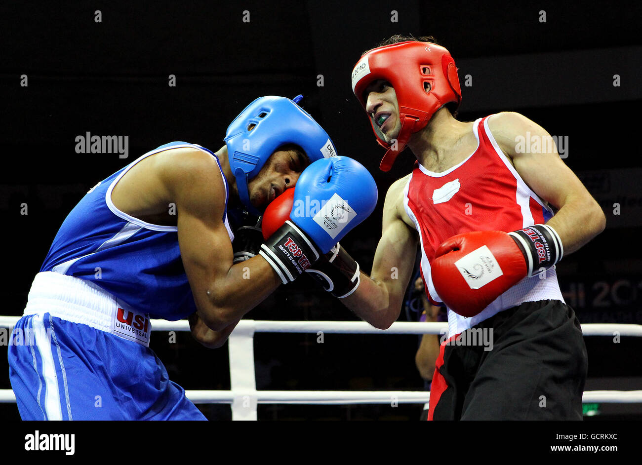 Pakistan's Haroon Kahn (red) in action against Mauritius' Gilbert ...