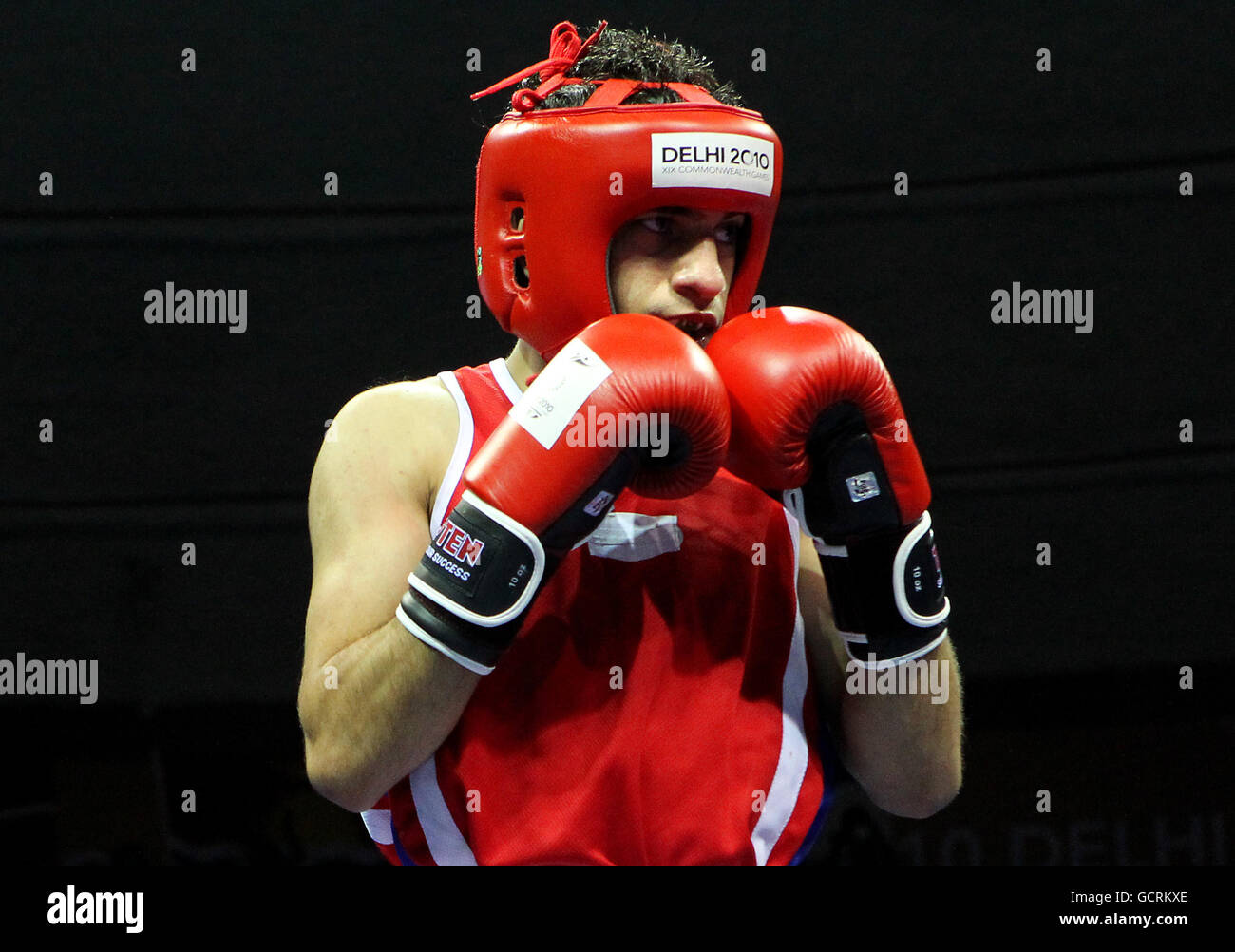 Pakistan's Haroon Kahn (red) in action against Mauritius' Gilbert ...