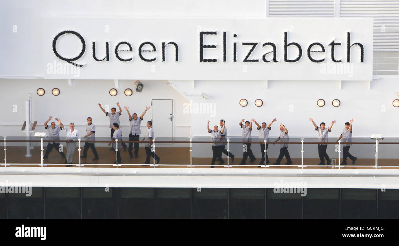 Crewmembers aboard Cunard's newest ship the Queen Elizabeth wave as ...